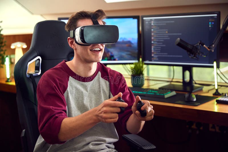 Man Wearing Virtual Reality Headset Gaming at Home Sitting at Desk with ...