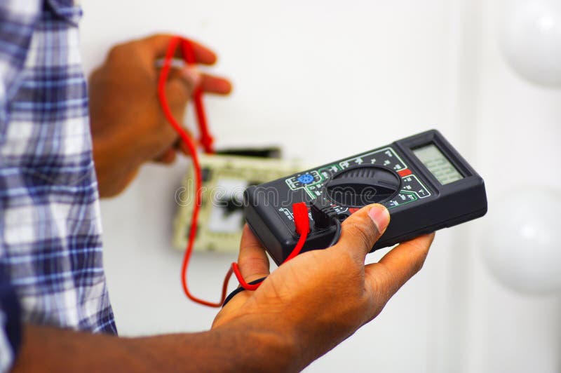 Man Wearing White and Blue Shirt Working on Electrical Wall Socket ...