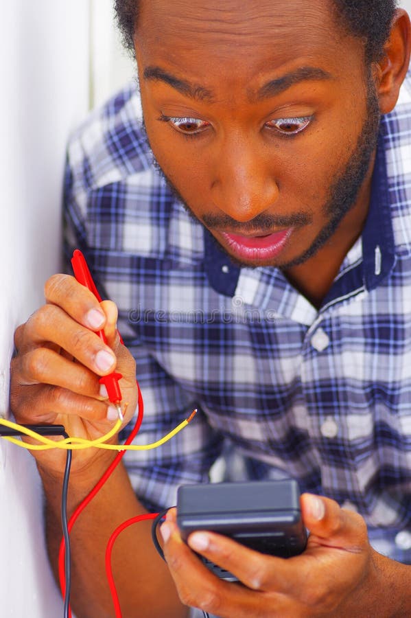 Man Wearing White and Blue Shirt Working on Electrical Wall Socket ...