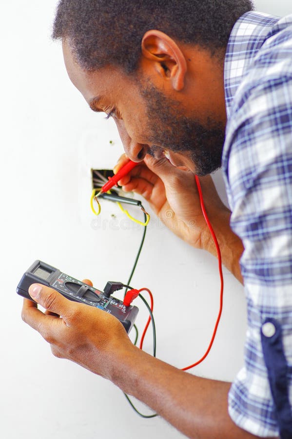 Man Wearing White and Blue Shirt Working on Electrical Wall Socket ...