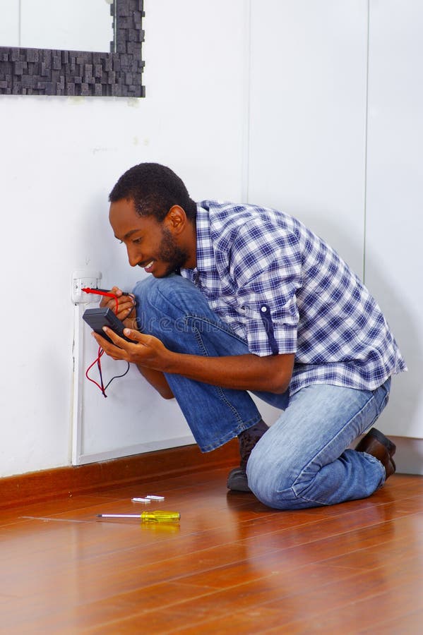 Man Wearing White and Blue Shirt Working on Electrical Wall Socket ...
