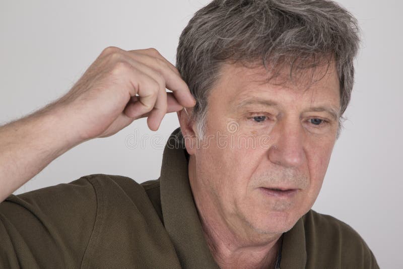 Man Wears a Hearing Aid and Places it in the Ear Stock Image - Image of ...