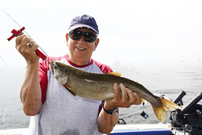 Man Weighing Large Fish - Lake Trout Stock Photo - Image of holding ...