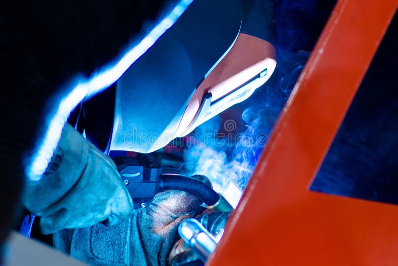 Man Weld a Metal with a Welding Machine Stock Photo - Image of ...