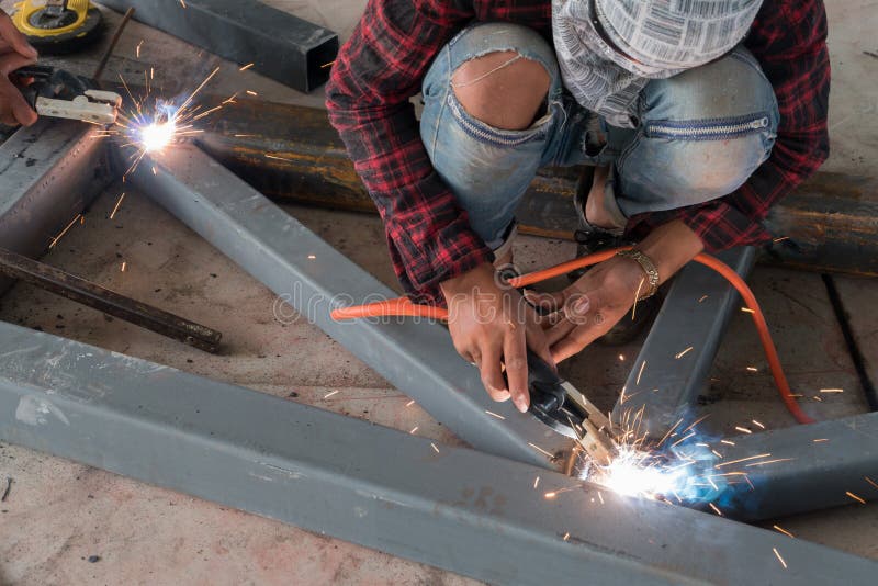 Man Weld a Metal with a Welding Machine. Stock Image - Image of ...
