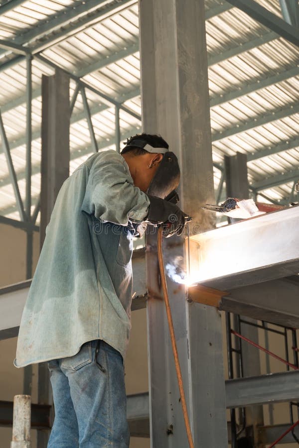 Man Weld a Metal with a Welding Machine. Stock Photo - Image of ...