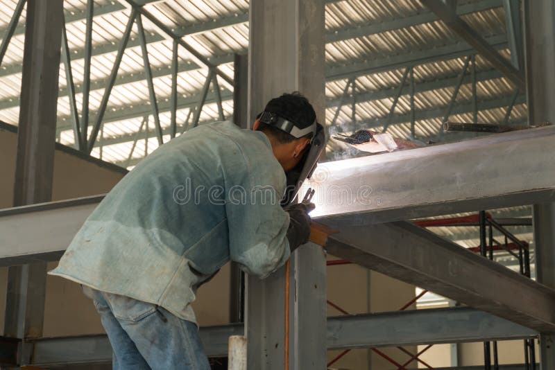 Man Weld a Metal with a Welding Machine. Stock Photo - Image of energy ...