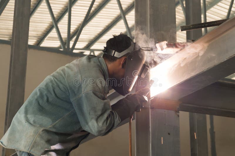 Man Weld a Metal with a Welding Machine. Stock Photo - Image of helmet ...