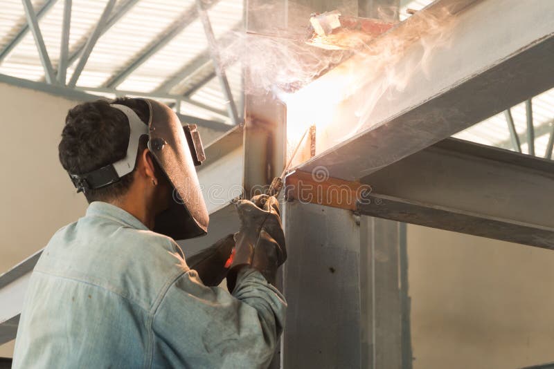 Man Weld a Metal with a Welding Machine. Stock Photo - Image of ...