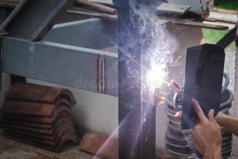 Man Welder Doing a Metal Staircase Structure in a Residential Building ...