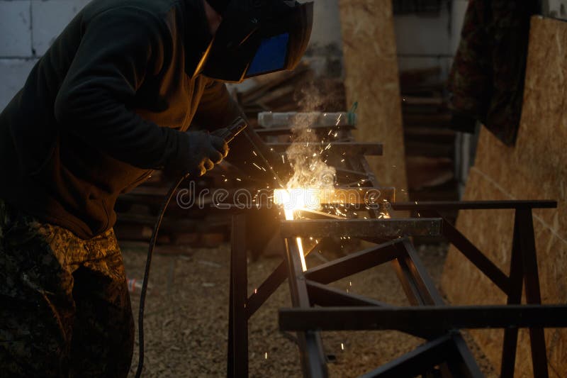 A Man is Welding Metal in a Workshop Stock Image - Image of dynamic ...