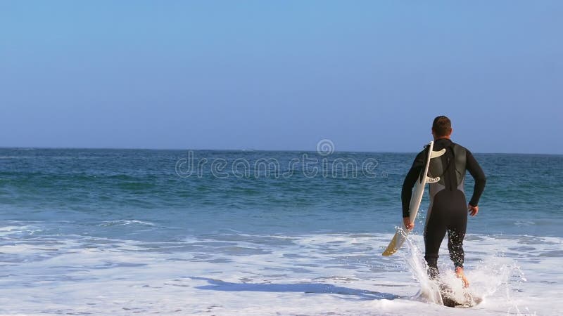 Man in Wet Suit Running into Water Stock Video - Video of slowmotion ...