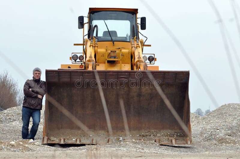 Man at wheel loader stock photo. Image of prevent, machine - 30376898
