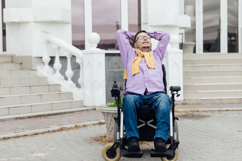 Man in a Wheelchair is Resting on a Walk through the Streets Stock ...