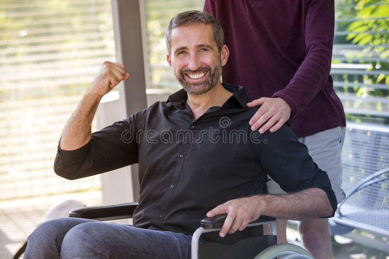 Man in Wheelchair Smiling and Looking Optimistic Stock Photo - Image of ...