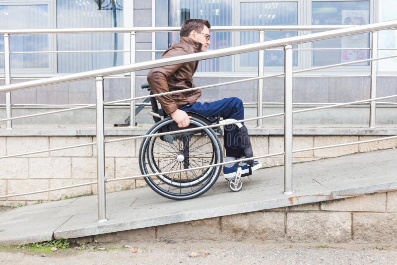 Man in a Wheelchair Use a Wheelchair Ramp. Stock Photo - Image of ...