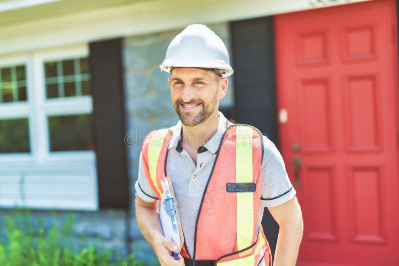 Man with a White Hard Hat Holding a Clipboard, Inspect House Stock ...