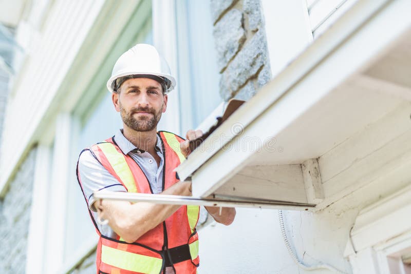 Man with a White Hard Hat Holding a Clipboard, Inspect House Stock ...