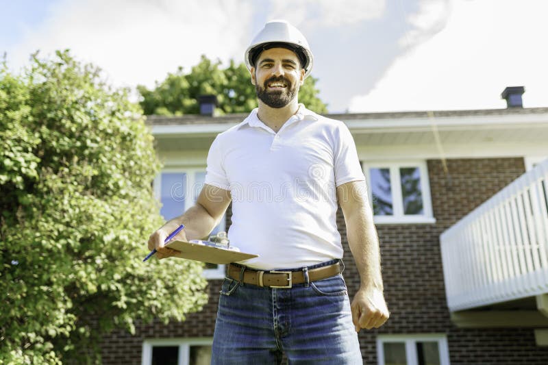 Man with a White Hard Hat Holding a Clipboard, Inspect House Stock ...
