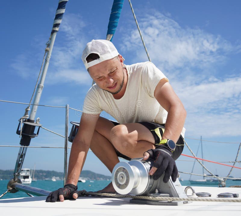 A Man in a White Hat is Working on a Voyage Boat Stock Photo - Image of ...