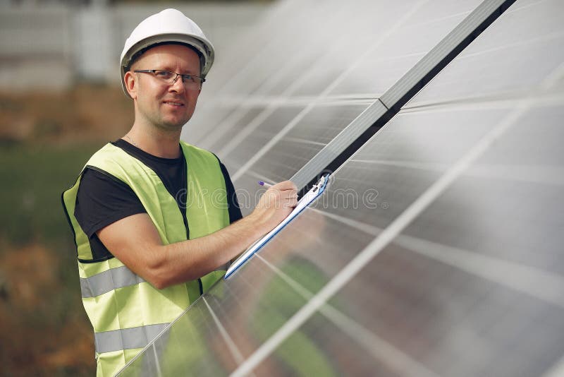 Man in a White Helmet Near a Solar Panel Stock Photo - Image of array ...