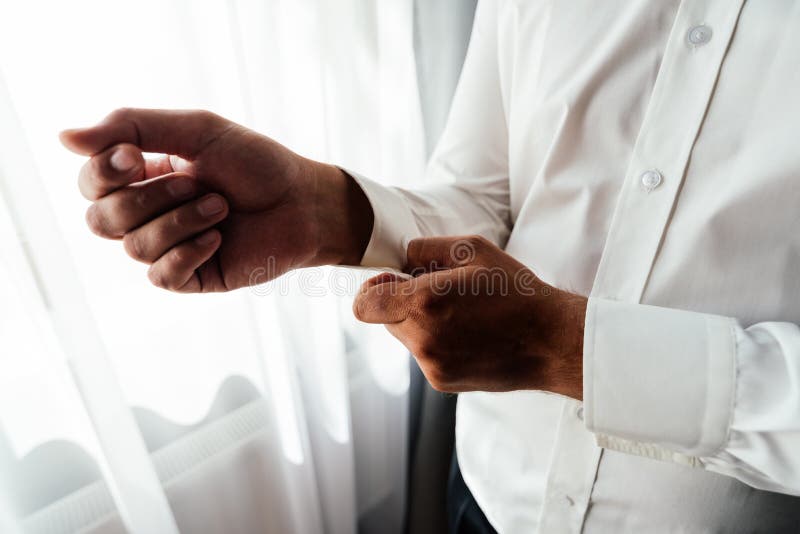 Man in a White Shirt Buttoning a Button on Shirt Cuff Stock Image ...