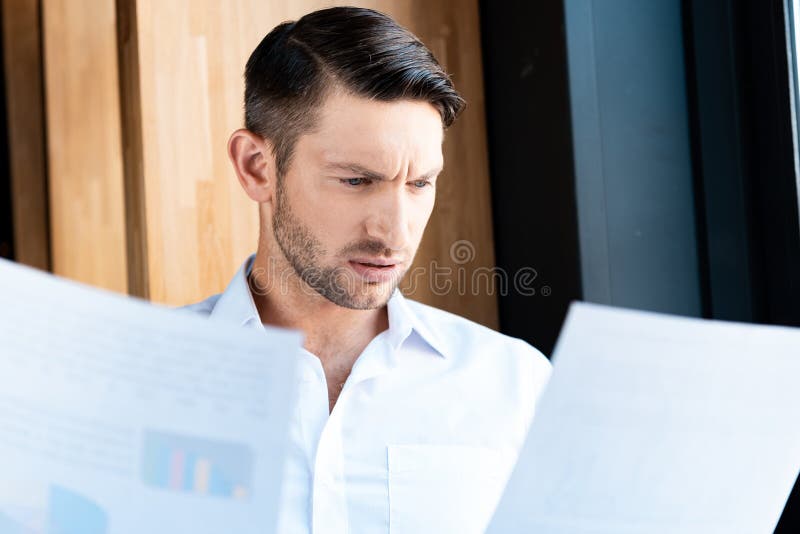 Man in White Shirt Looking at Documents Stock Photo - Image of ...