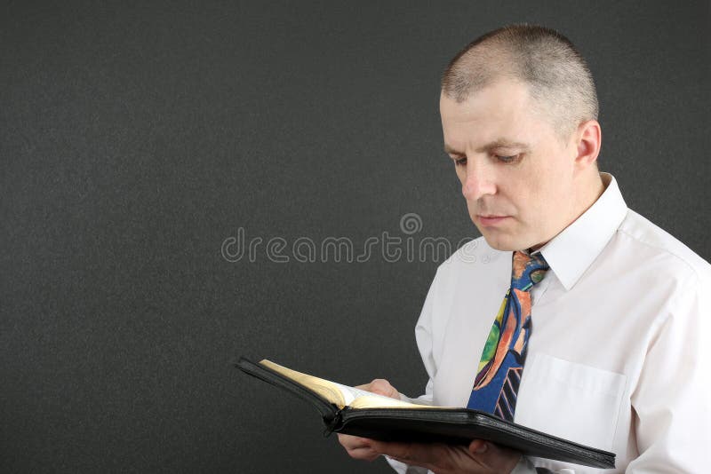Man in a White Shirt Reading a Book Stock Photo - Image of people ...