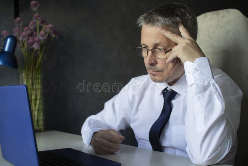 A Man in a White Shirt is Working at Home on a Laptop. Remote Work ...