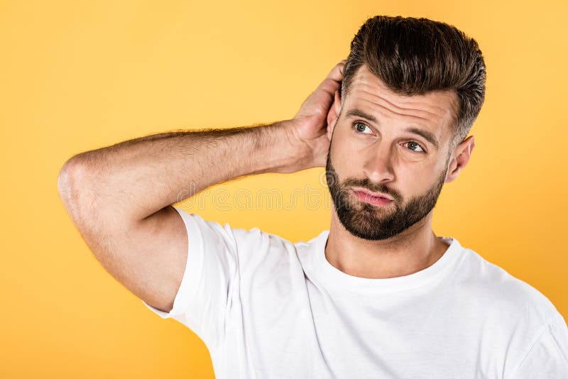Man in White T-shirt Scratching Head Isolated on Yellow Stock Photo ...