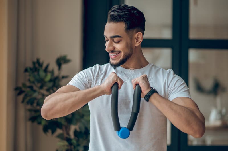 A Man in a White Tshirt Exercising with Expander Stock Image - Image of ...