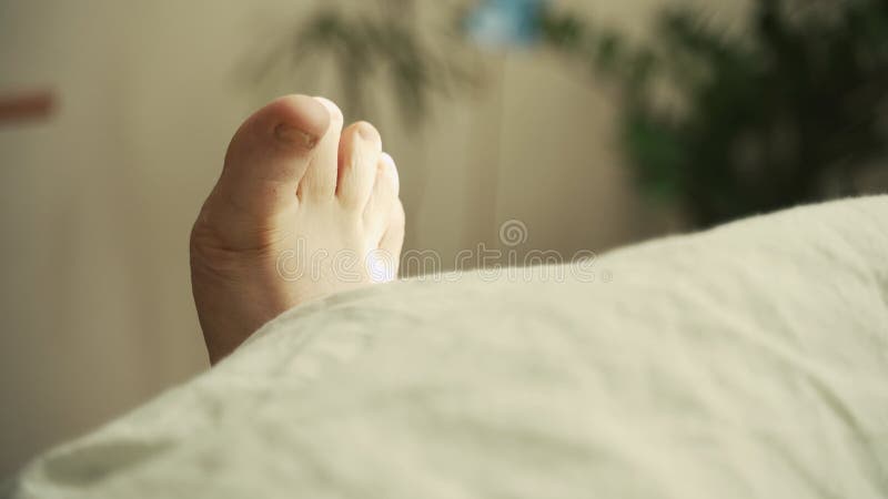 The Man Wiggles His Toes, Pulling Her Out from Under the Covers. Stock ...