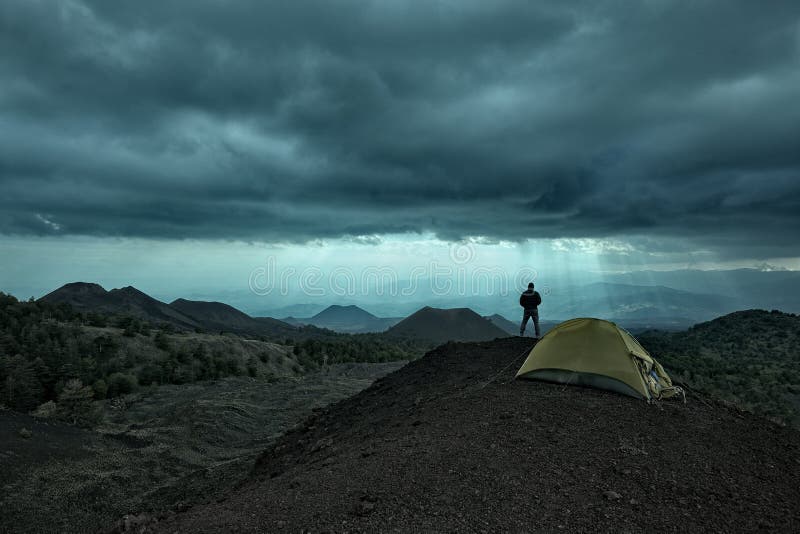 Man by Wild Camp Looking Dramatic Light in the Sky on Etna Park Stock ...