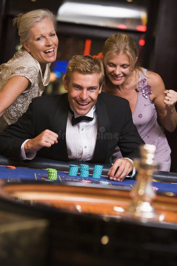 Man Winning at Roulette Table Surrounded by Glamor Stock Photo - Image ...