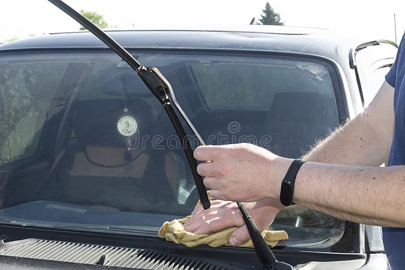 A Man Wipes the Windshield of a Car. Stock Photo - Image of cloth ...