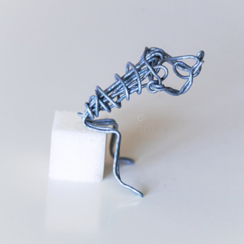 A Man of Wire Sits in the Pose of a Thinker, Raising His Hand To His ...