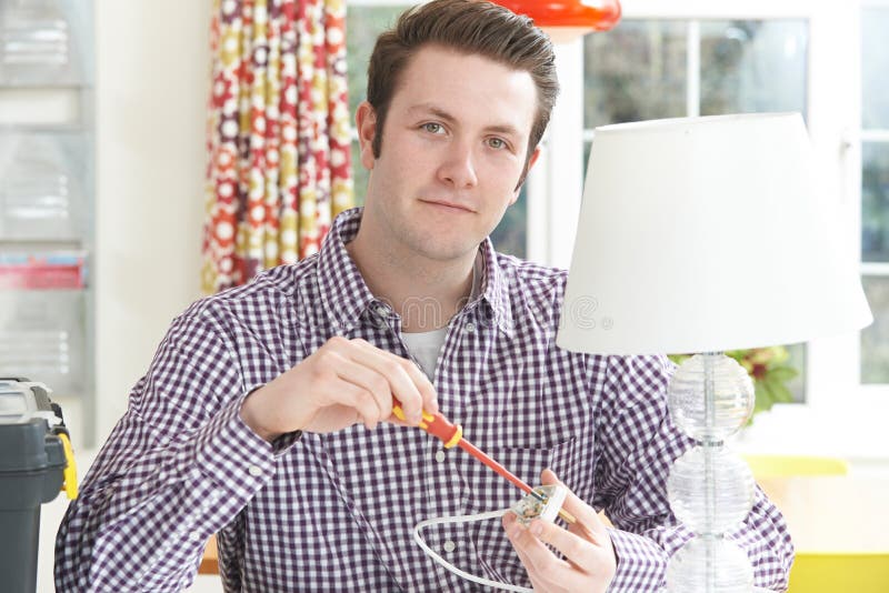 Man Wiring Electrical Plug on Lamp at Home Stock Image - Image of ...