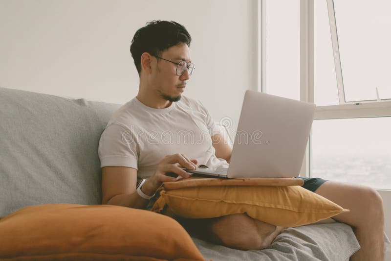 Man Woking Boring Job with Computer in His Room Sitting on the Sofa ...