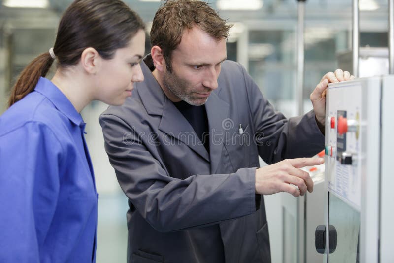 Man and Woman Apprentice with Machine Cnc Stock Image - Image of ...