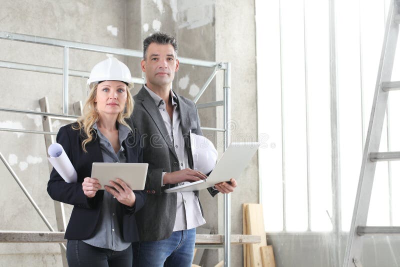 Man and Woman Architects or Engineers with Computer Work Together in ...