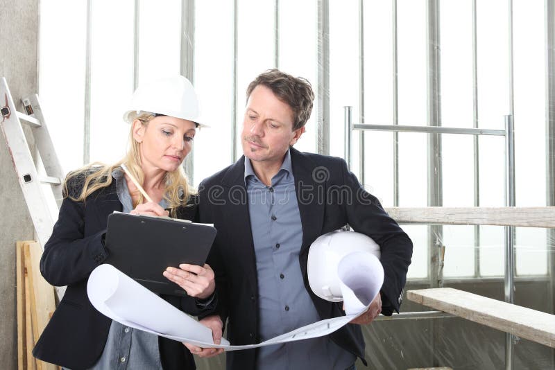 Man and Woman Architects or Engineers Work Together Discussing with ...