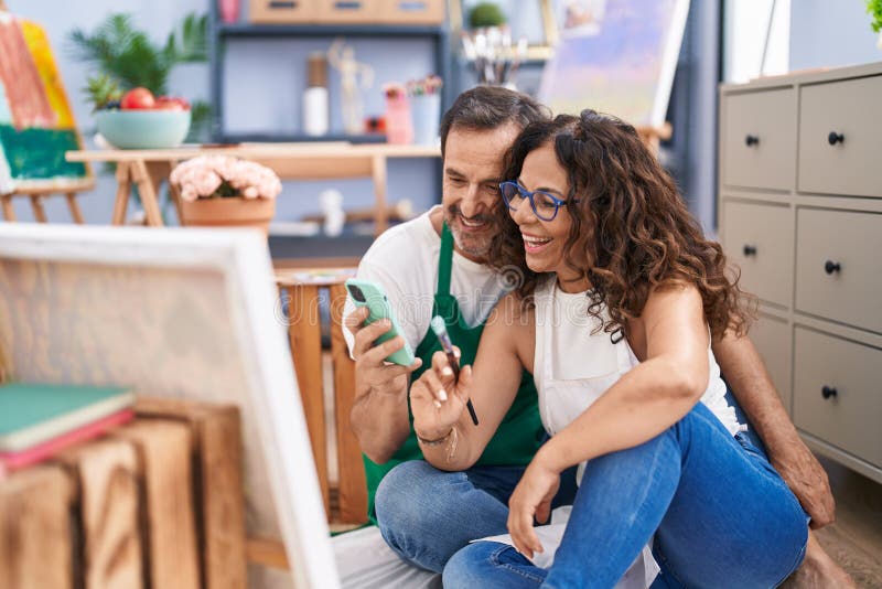 Man and Woman Artists Using Smartphone Drawing at Art Studio Stock ...