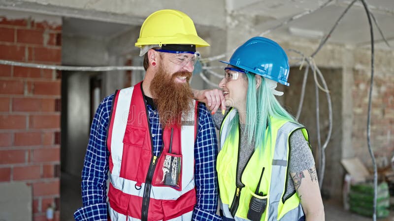 Man and Woman Builders Smiling Confident Standing Together at ...