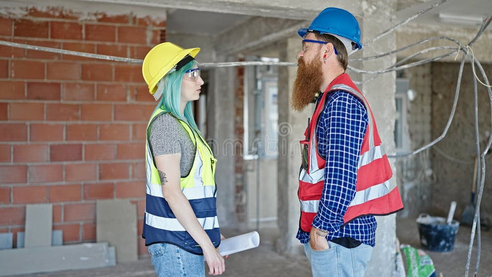 Man and Woman Builders Standing with Relaxed Expression Working at ...