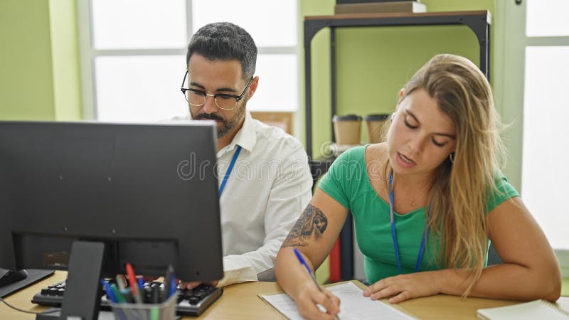 Man and Woman Business Workers Using Computer Taking Notes at Office ...