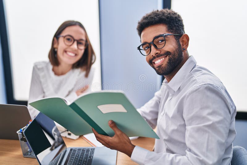 Man and Woman Business Workers Using Laptop Reading Notebook at Office ...
