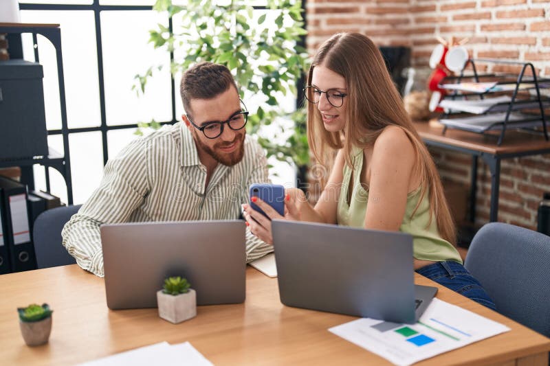 Man and Woman Business Workers Using Laptop and Smartphone at Office ...