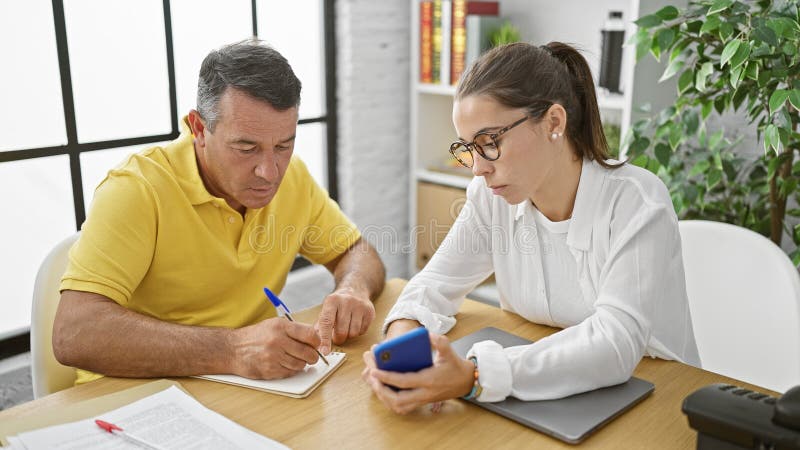 Man and Woman Business Workers Using Smartphone Taking Notes at the ...