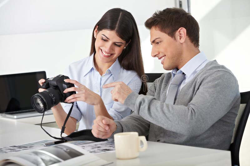 Man and Woman with Camera in Office Stock Image - Image of person ...