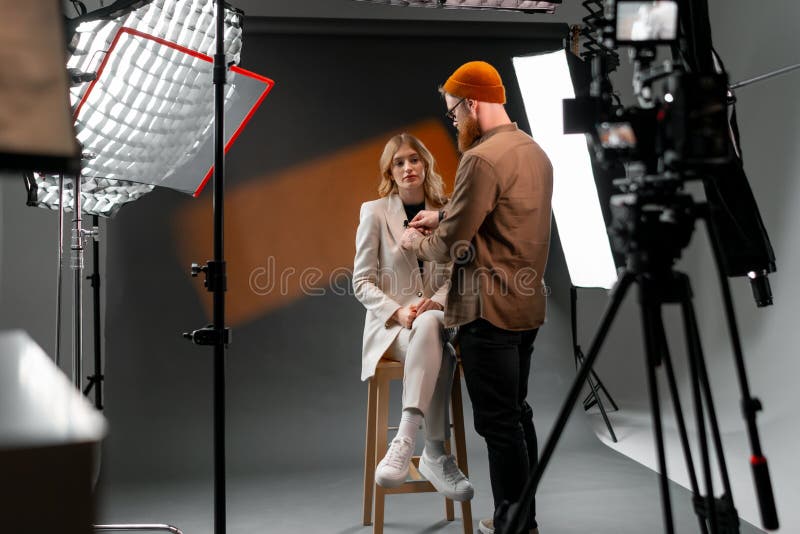 A Man and Woman Chat on Camera with Stage Equipment Stock Image - Image ...